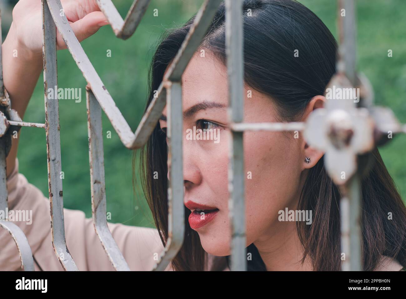 People standing behind security fence hi-res stock photography and ...