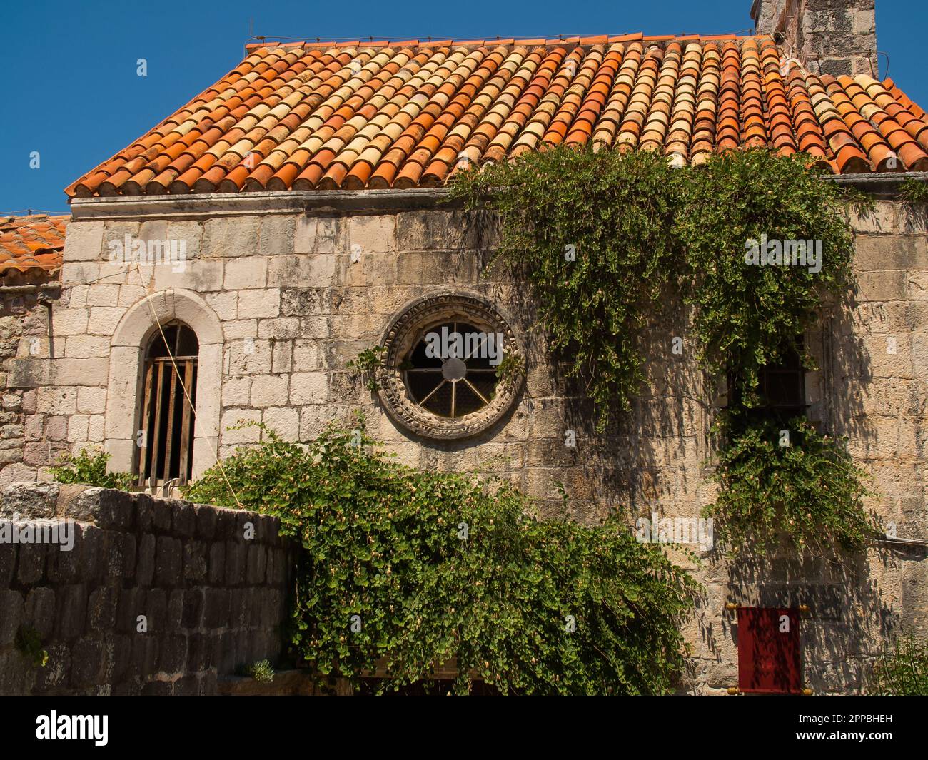 Round window in an old brick house. Traditional house. Elements of ...