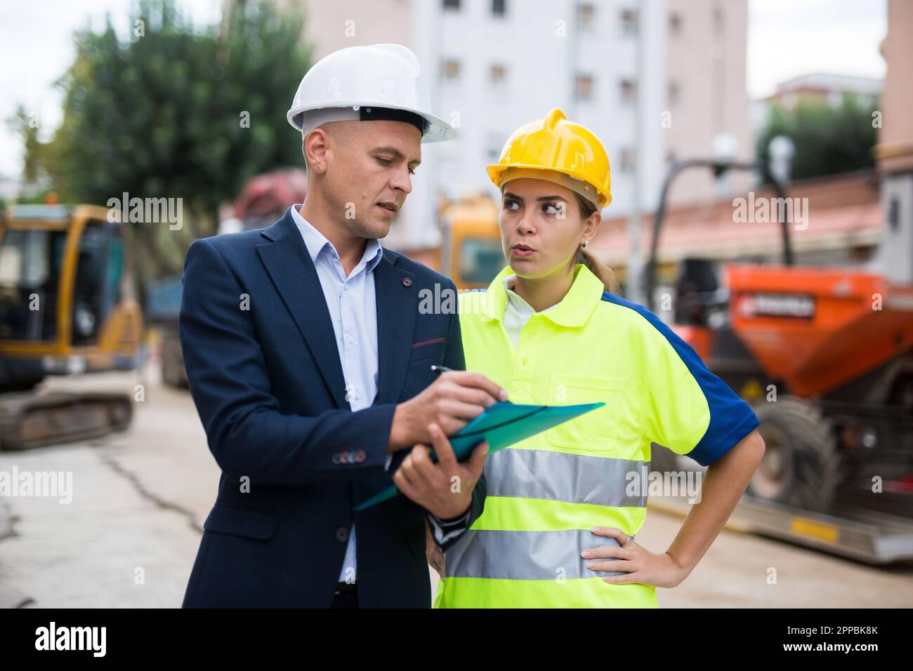 Male and female engineers in construction area Stock Photo - Alamy
