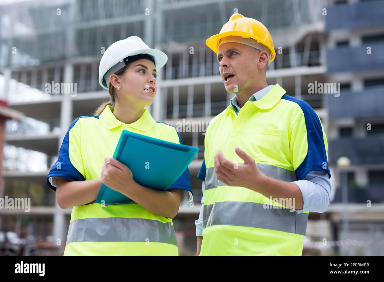 Two builders planning their work in construction plant Stock Photo - Alamy