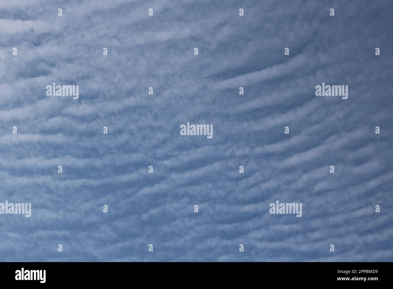 Full frame of pretty blue sky with unusual scudding cloud formation ...