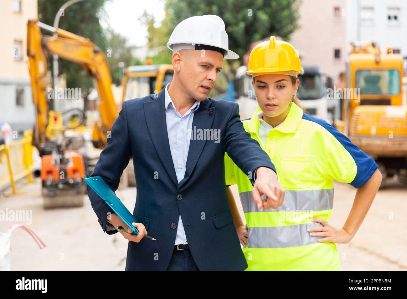 Civil engineers checking work process in construction site Stock Photo ...