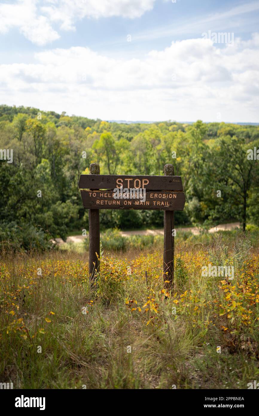 old trail sign at the hills end looking for a forest, "stop to help ...