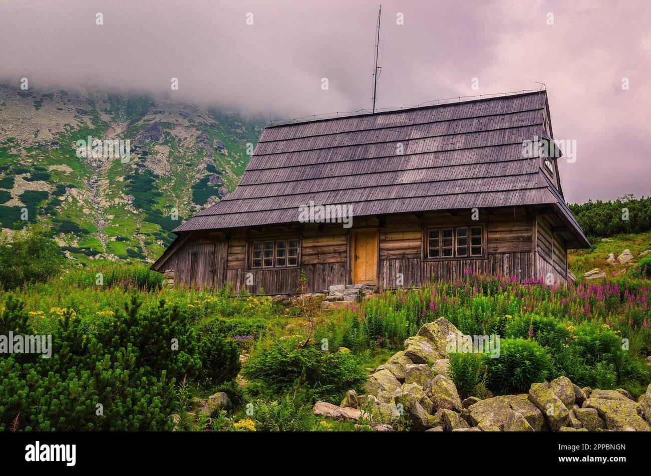 Wooden hut in mountain cloudy scenery. Old wooden cabin can be used as ...