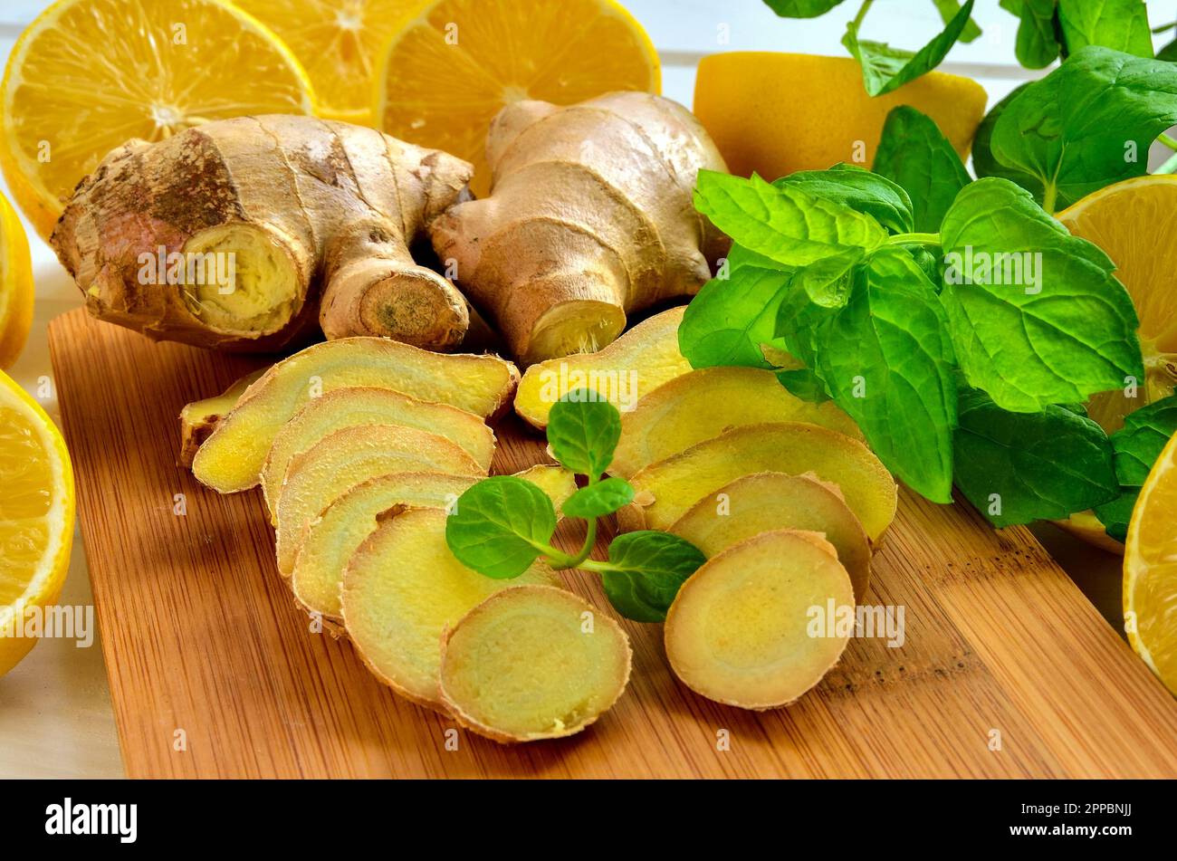 Lemons, ginger and mint leaves. Lemon halves, slices of ginger and mint ...
