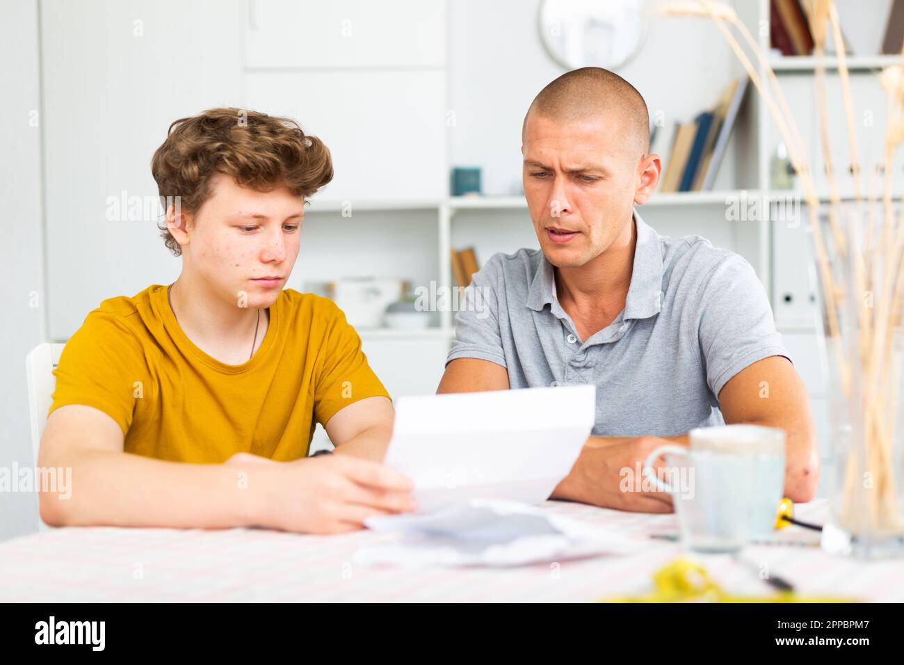 Father reassures his son after reading letter from college Stock Photo ...
