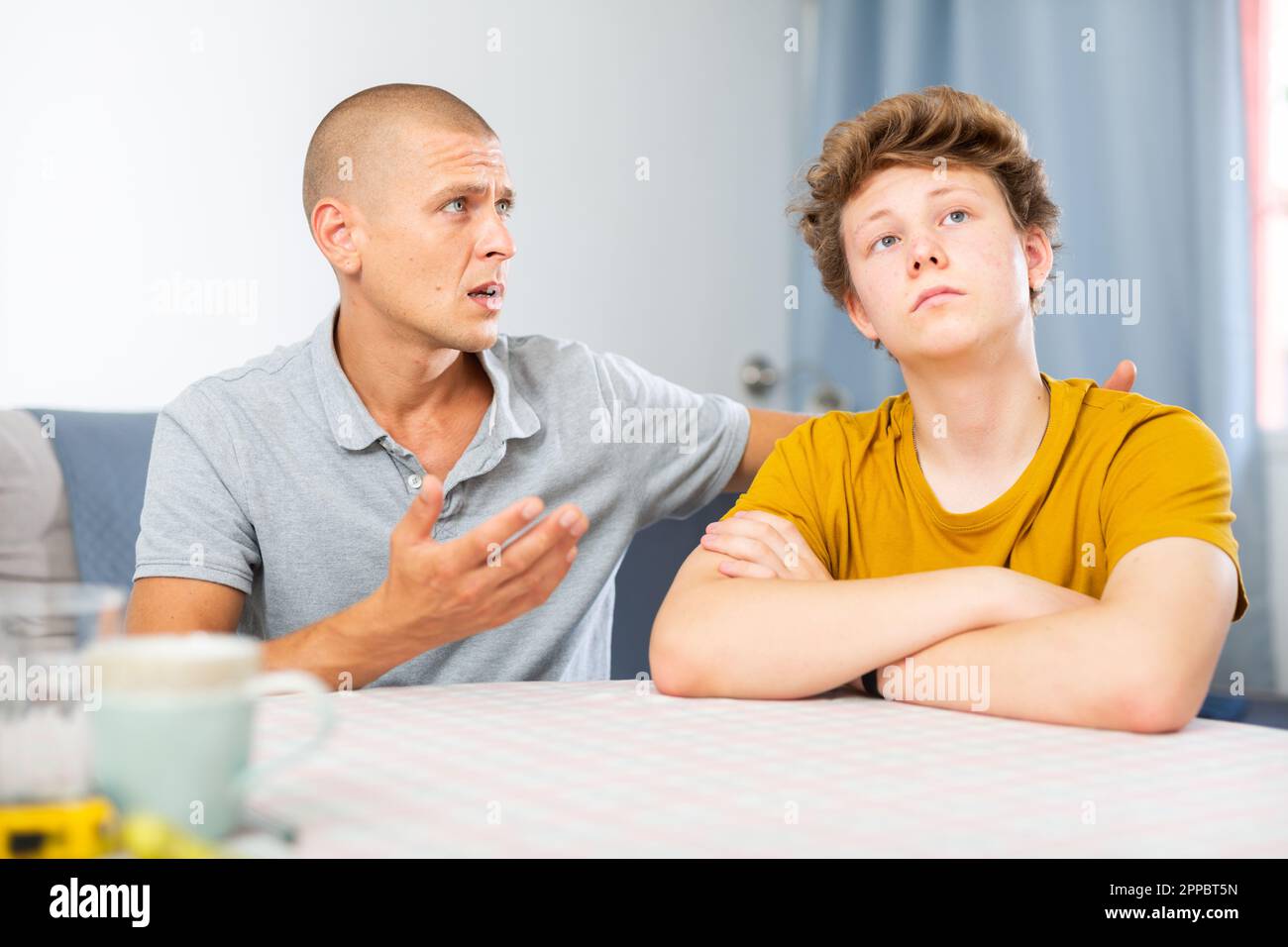 Teenager feeling upset and his father comforting him Stock Photo - Alamy