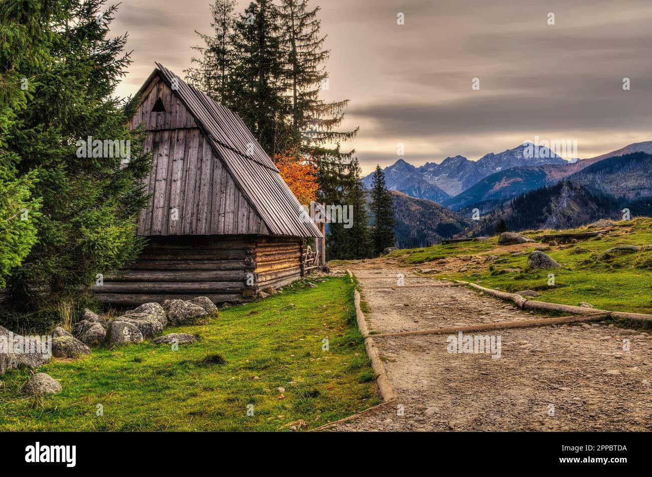Wooden hut and path in beautiful mountains. Beautiful rural landscape ...