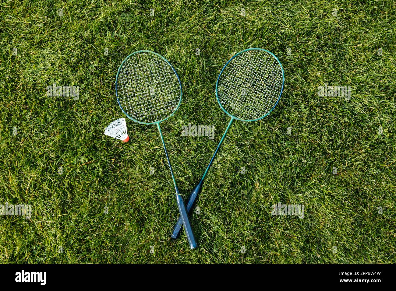 badminton rackets and shuttlecock on grass Stock Photo - Alamy