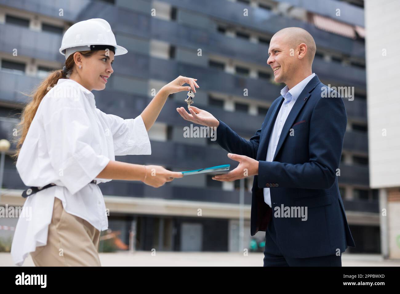 Builder giving keys to client after finishing signing contract Stock ...