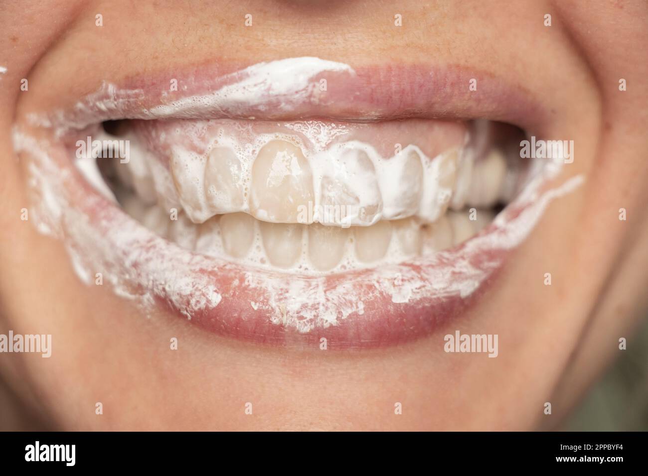 female teeth in toothpaste brushing teeth close up Stock Photo - Alamy