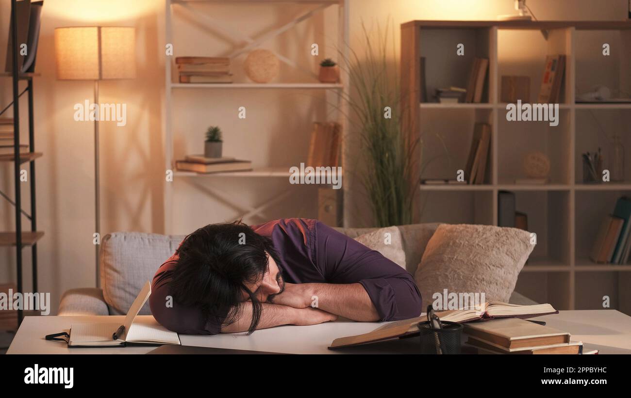 Desk nap student fatigue guy sleeping with books Stock Photo - Alamy