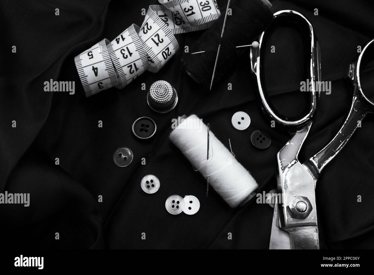 Old vintage sewing accessories. Needle with threads. Scissors ...