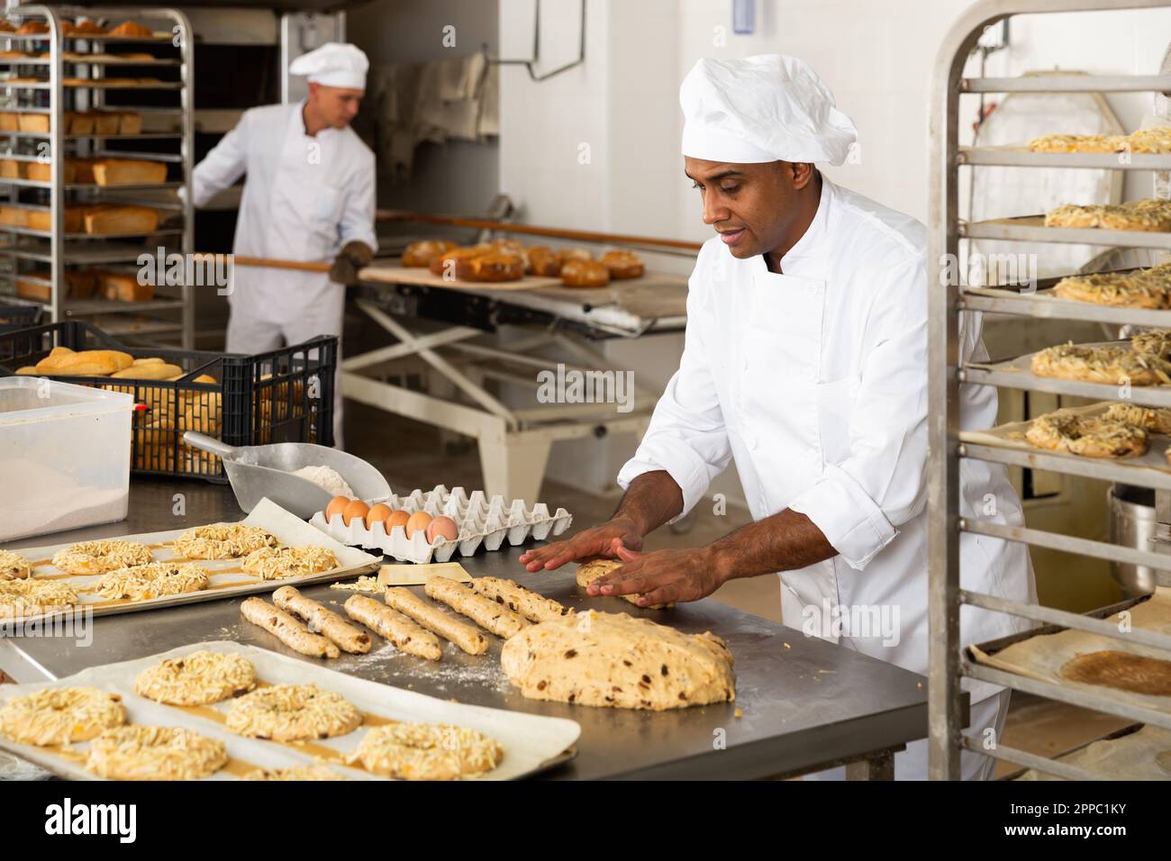 portrait of latino male baker making cookies in bakehouse Stock Photo ...