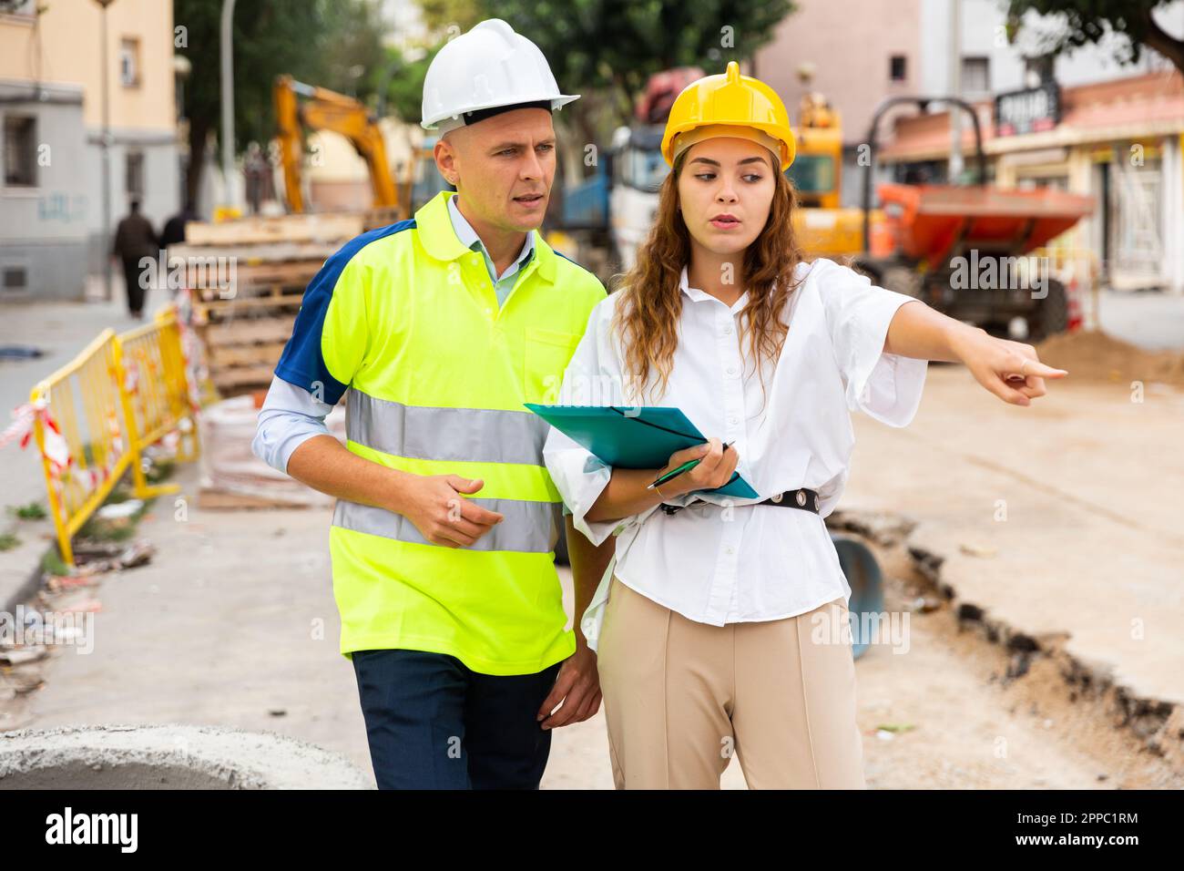 Civil engineers checking work process in construction site Stock Photo ...