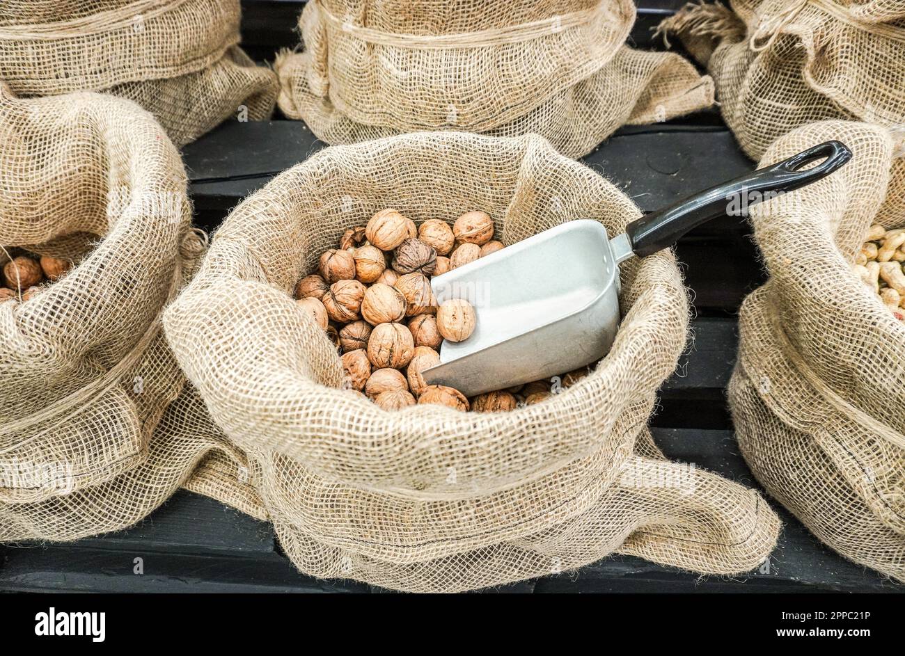 Unpeeled walnuts in a canvas bag are sold in a store Stock Photo - Alamy