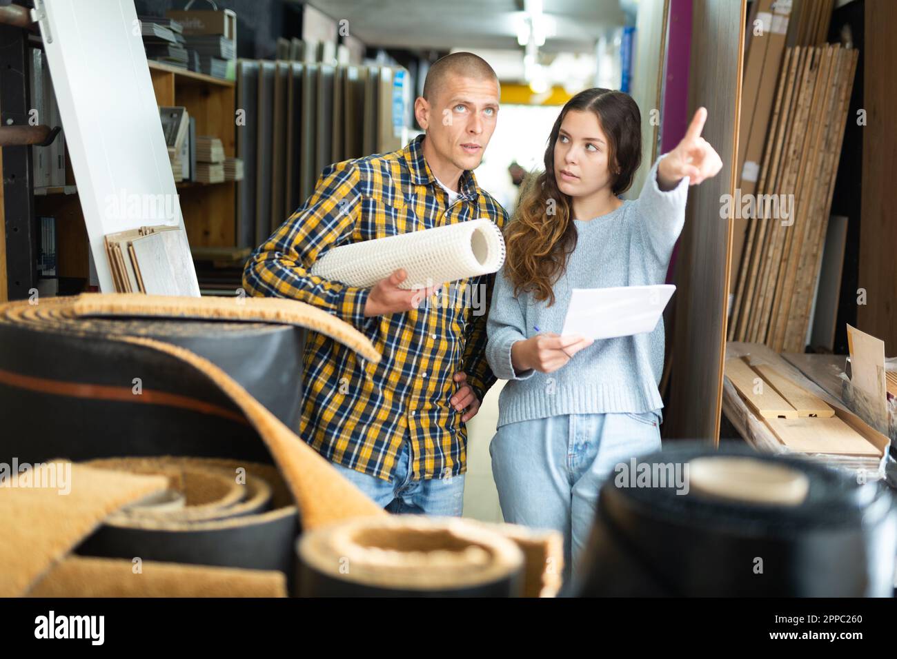 Seller points with his hand to something in hardware store Stock Photo ...