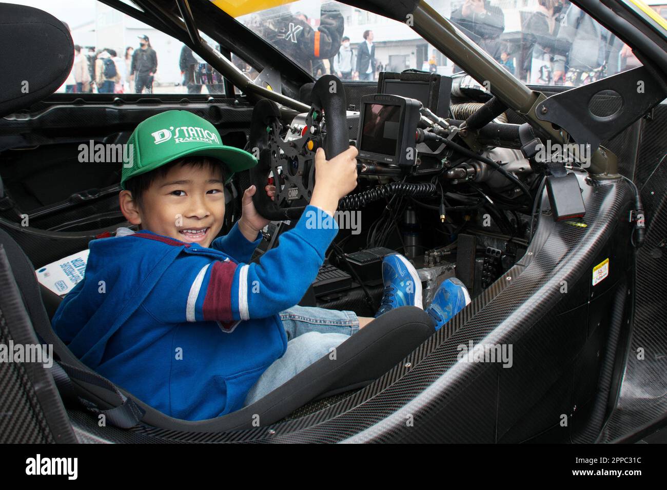 Oyama, Japan. 23rd Apr, 2023. A boy poses for camera during the "Motor Fan Festa 2023" at Fuji ...