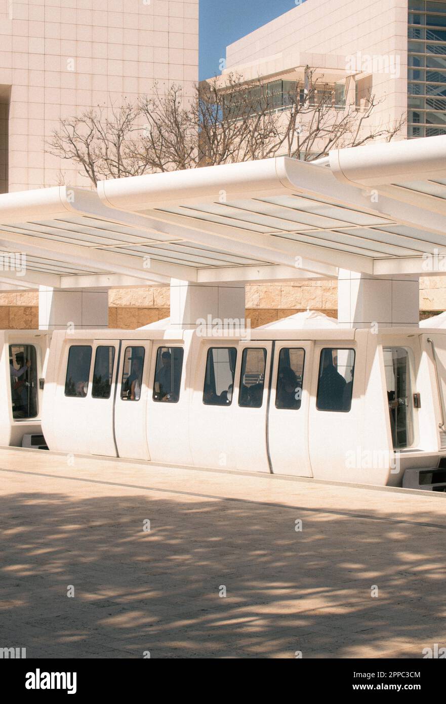 A white subway car is seen stationary at a station platform, ready for ...