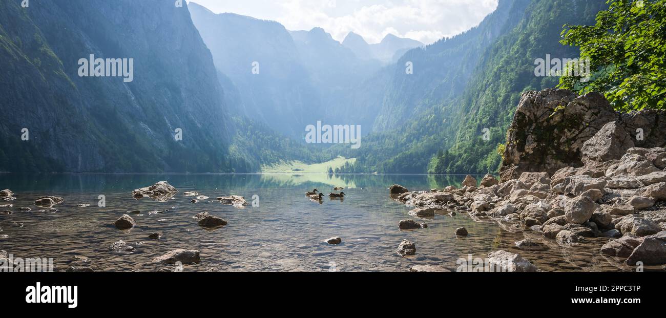 Pristine alpine lake located amongst mountains and high stone walls ...