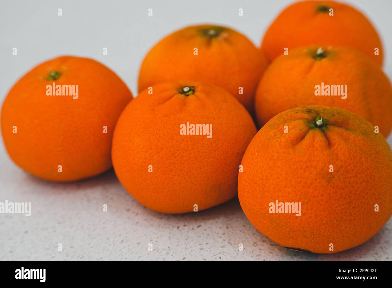 Tangerines packed in triangle with white background Stock Photo - Alamy