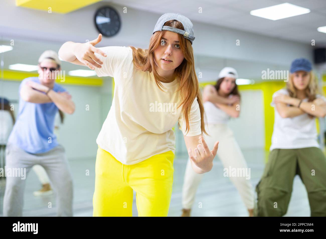 Teen girl in cap dances hip hop dances Stock Photo - Alamy