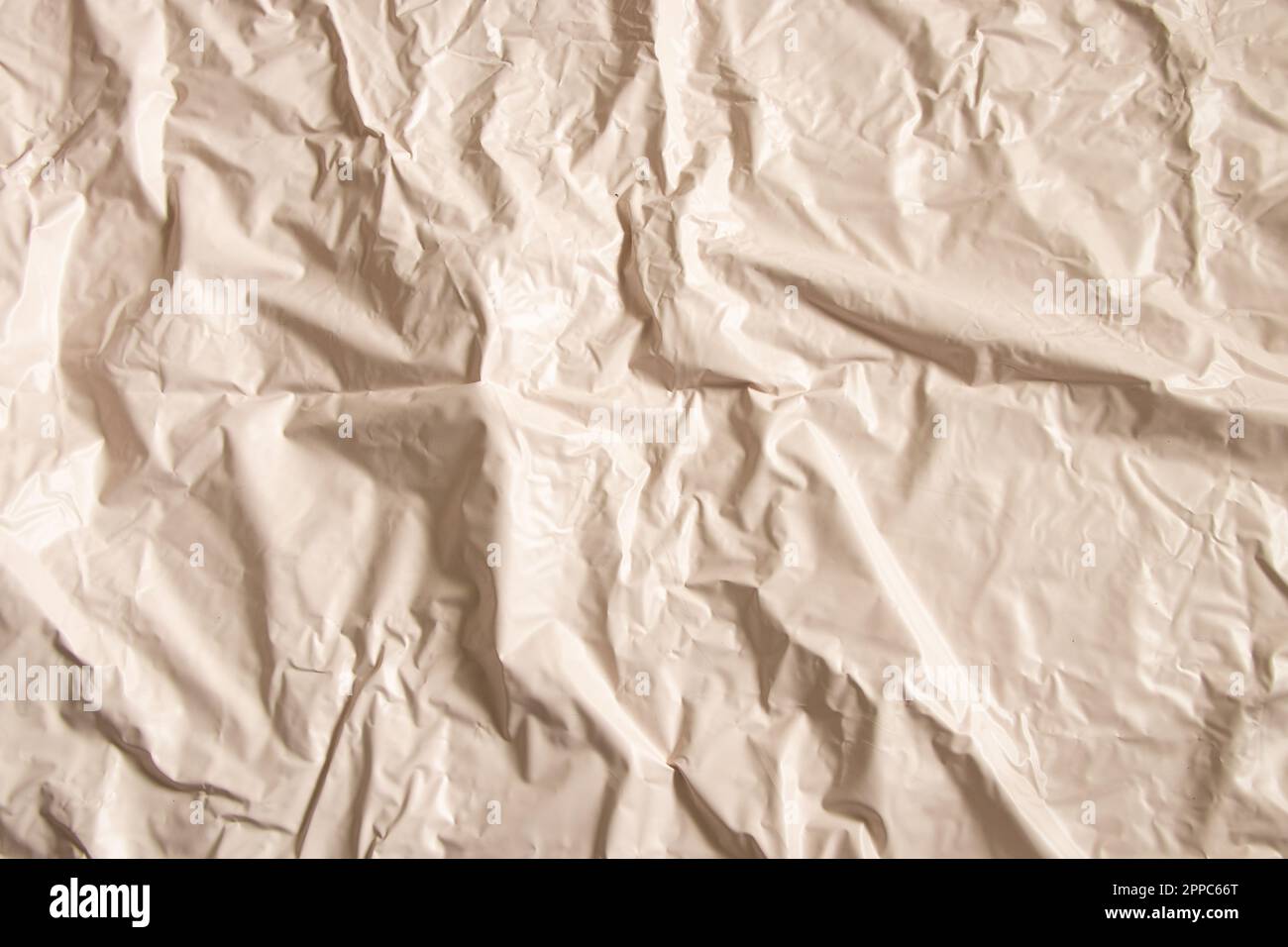 light beige glossy crumpled film as background for design Stock Photo ...