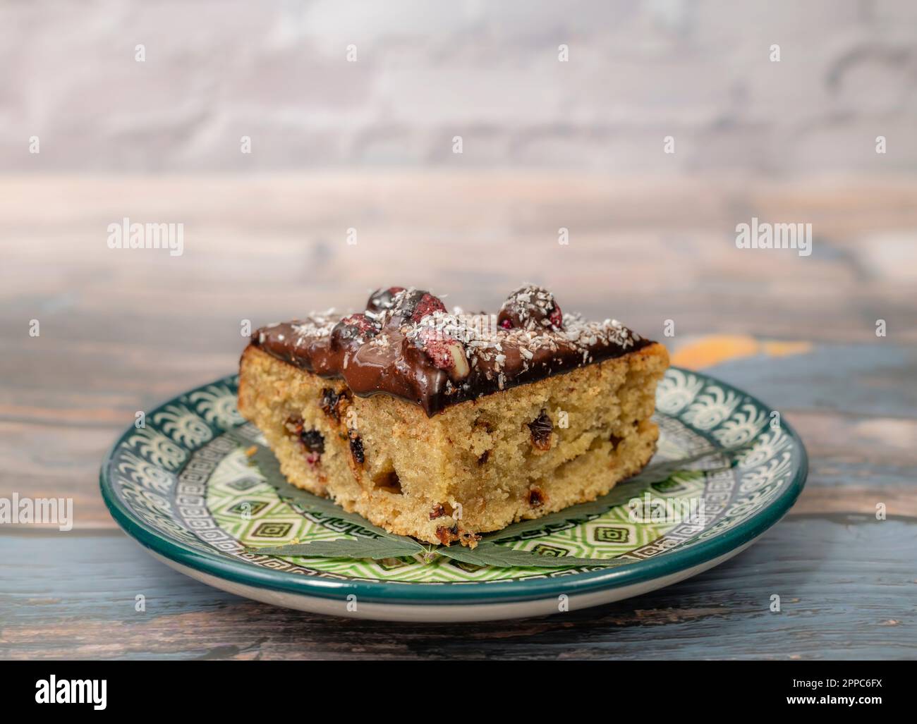 Marijuana cake with dry red currants and chocolate on arabic color ...