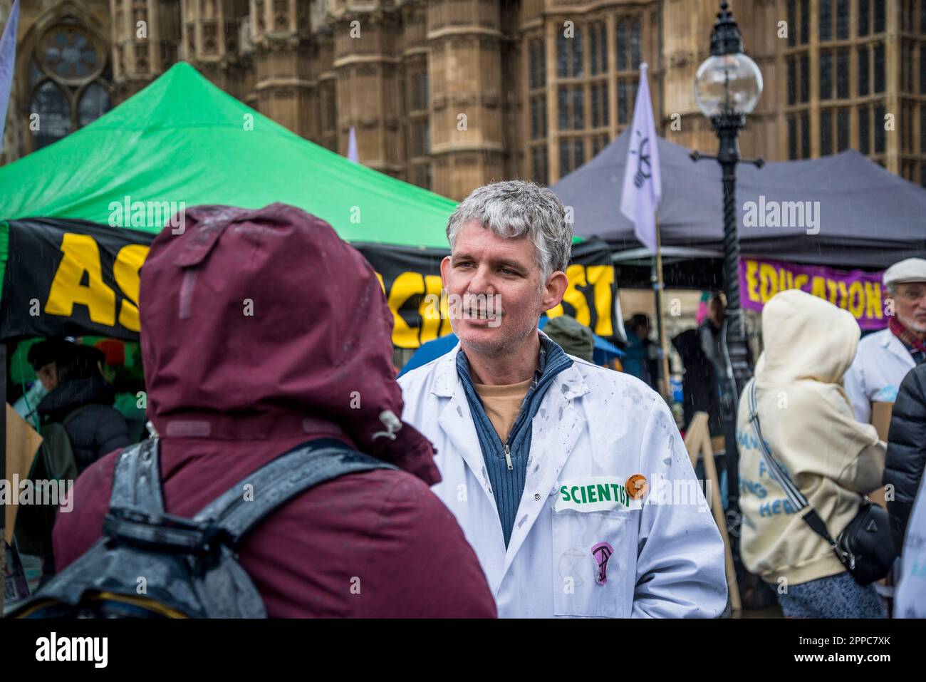 Person talking to a scientist at the Extinction Rebellion protest ...