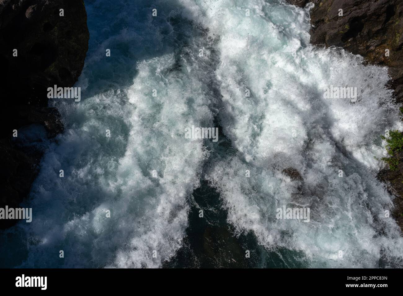 Swirling and surging river water below as the dam gates open at ...