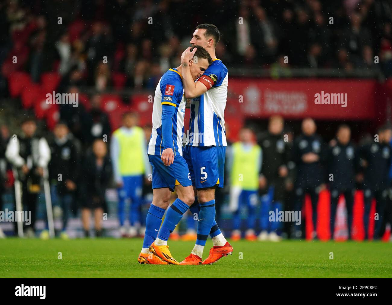 Brighton and Hove Albion's Lewis Dunk (right) comforts Solly March ...