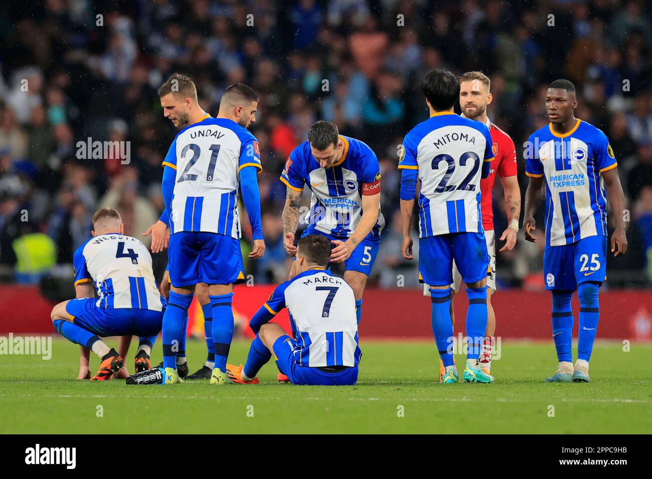 Brighton players show their disappointment at the end of the penalty ...
