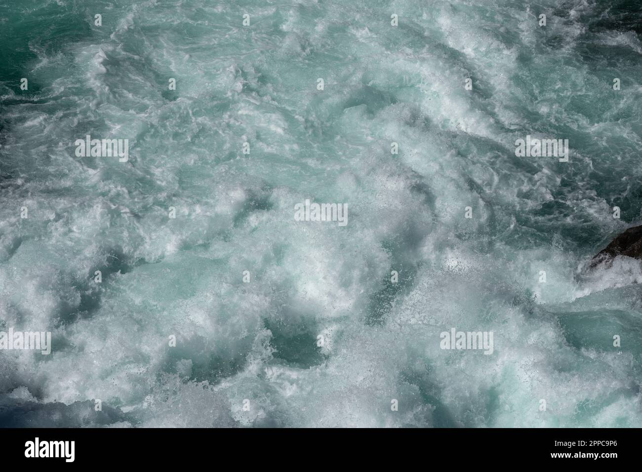 Swirling and surging river water below as the dam gates open at ...