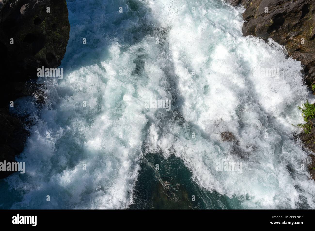 Swirling and surging river water below as the dam gates open at ...