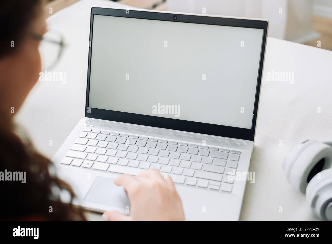 Over shoulder view of woman student elearning looking at white mock up ...