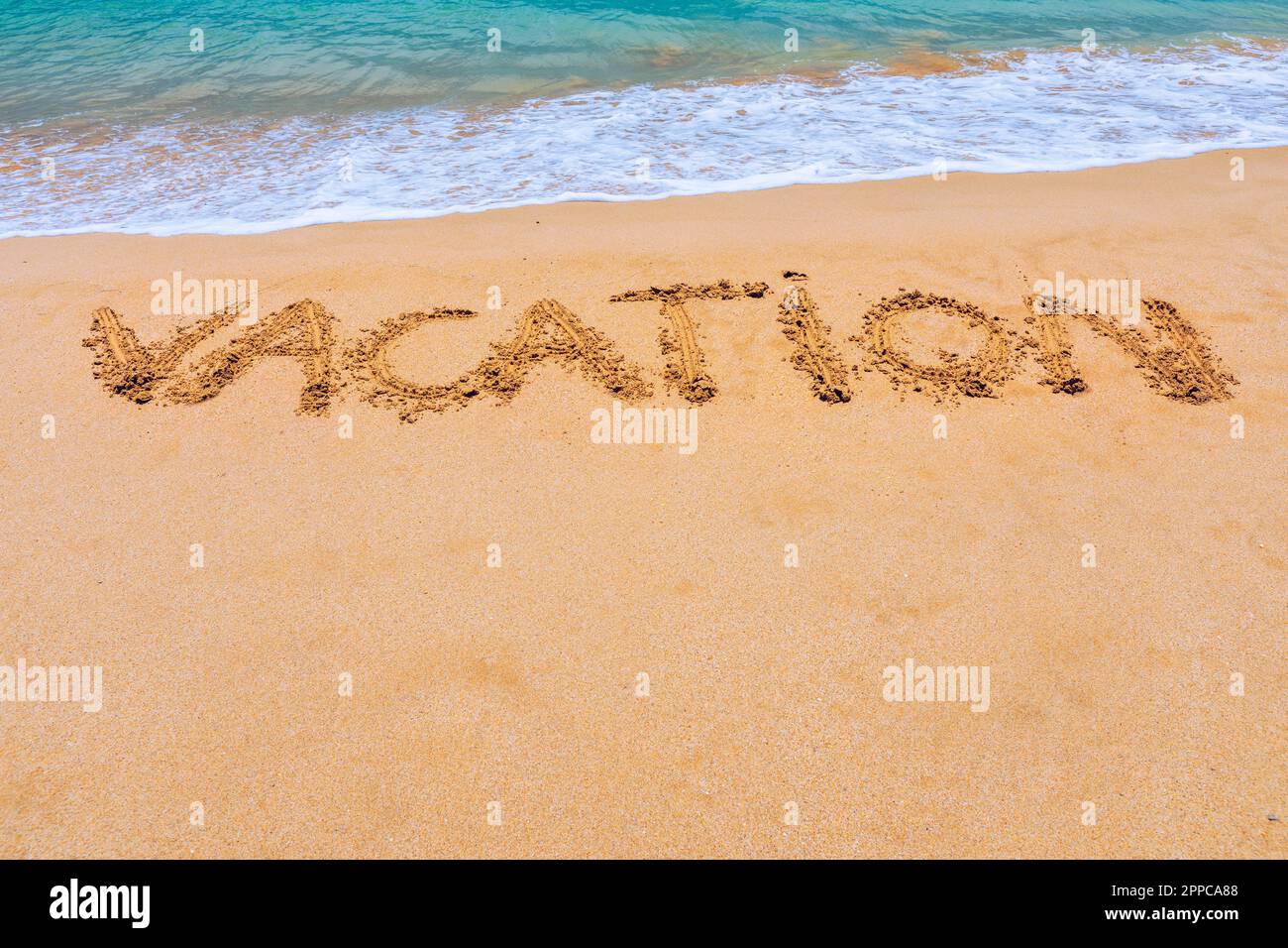 Vacation text on a beach. Vacation written in a sandy tropical beach ...