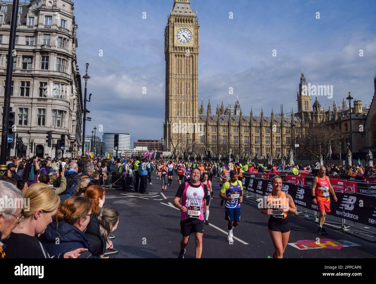 London, UK. 23rd April 2023. Runners pass by Big Ben and Houses of ...