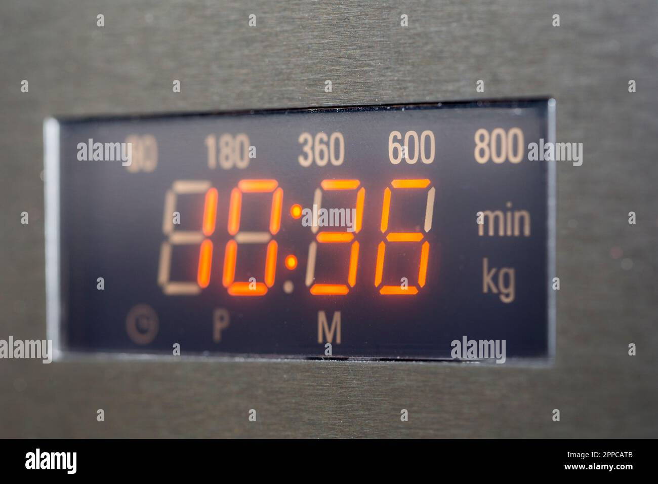 A stainless steel digital microwave oven with the timer displayed on ...