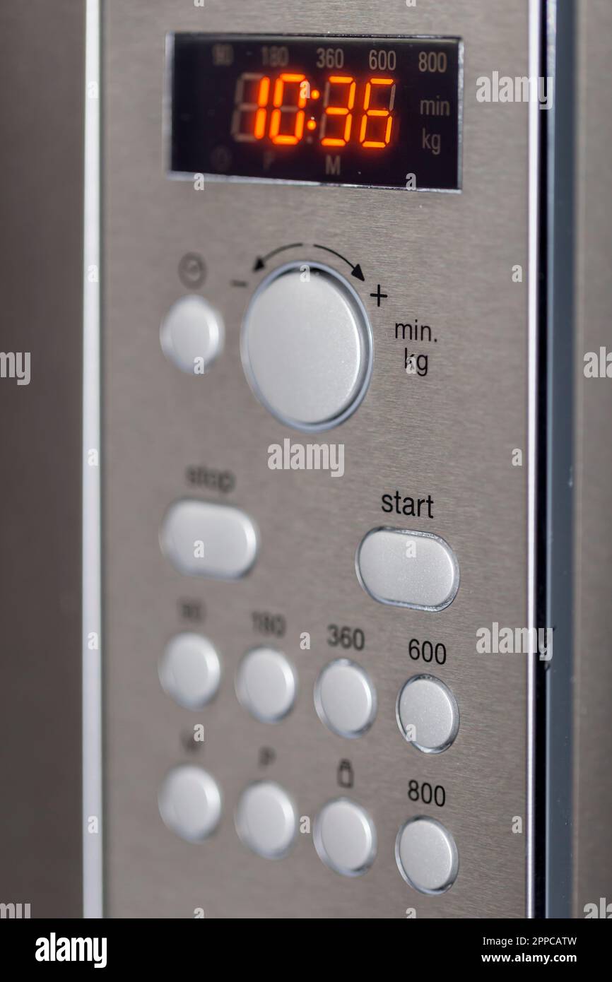 A stainless steel digital microwave oven with the timer displayed on ...