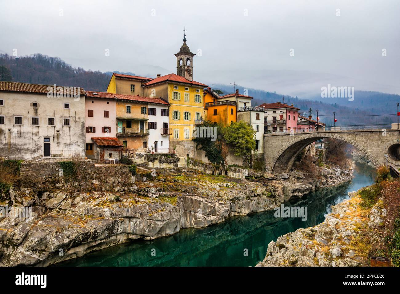 Beautiful ancient mediterranean town with stone arch bridge and emerald ...