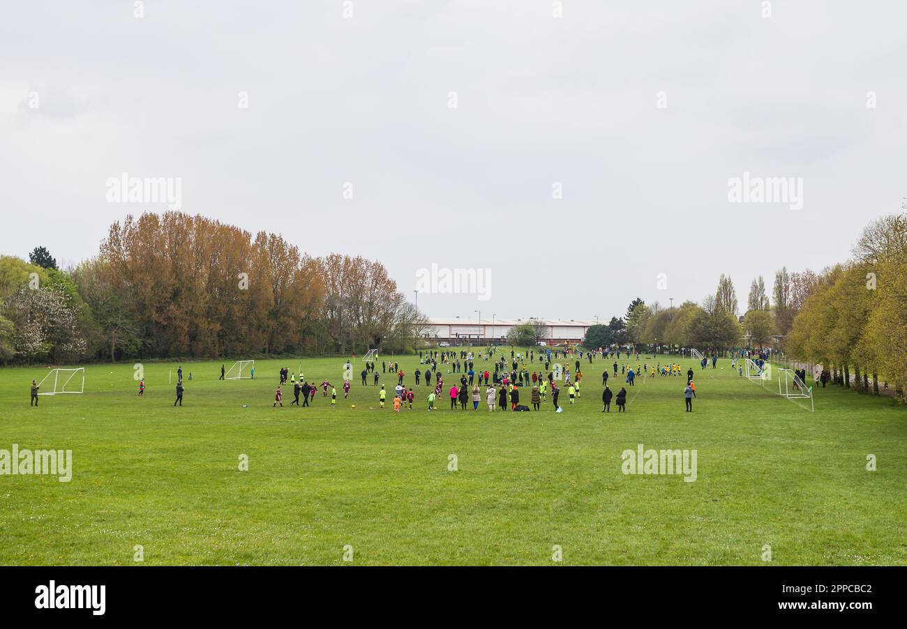 Numerous fields full of amateur children playing football in a park in ...