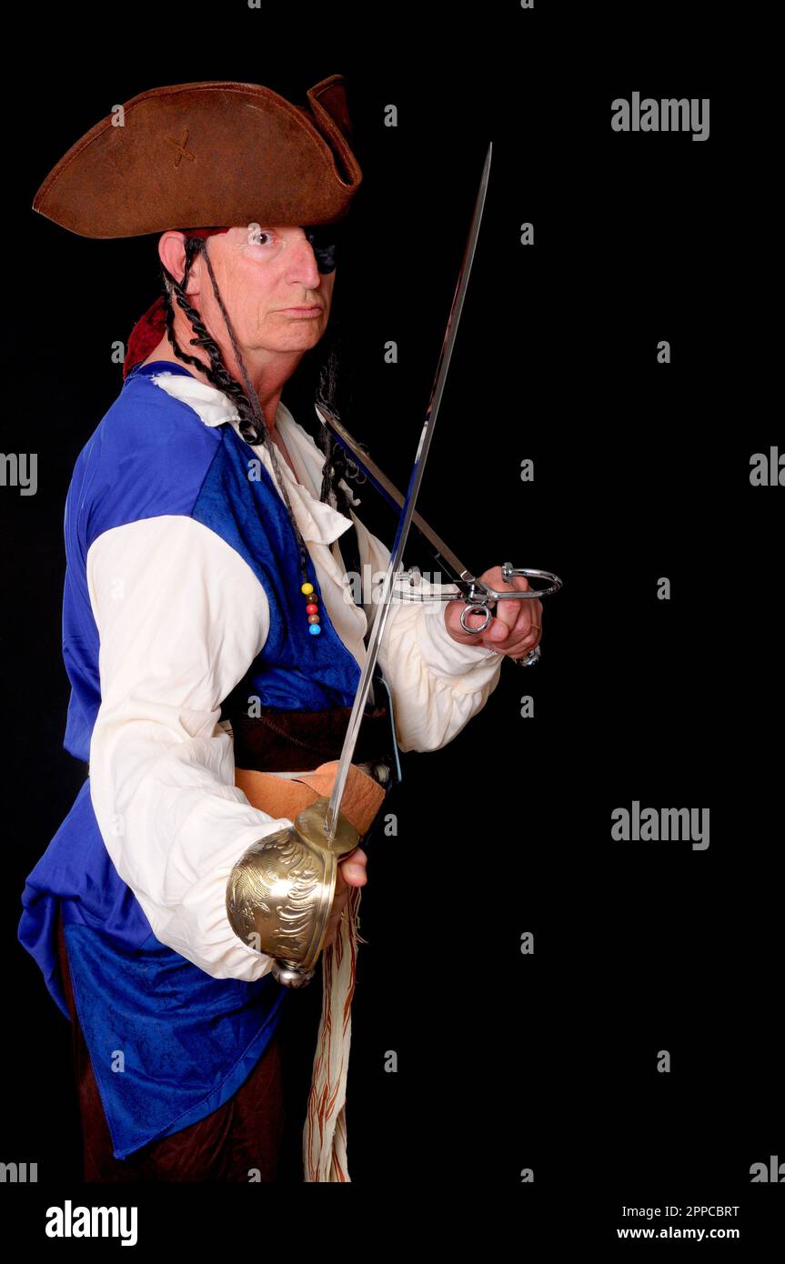 Pirate isolated on black with a cutlass Stock Photo - Alamy
