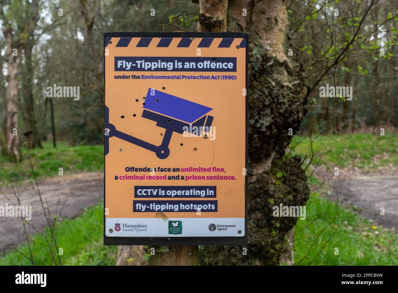 Fly-tipping is an offence sign in a rural countryside car park, England ...