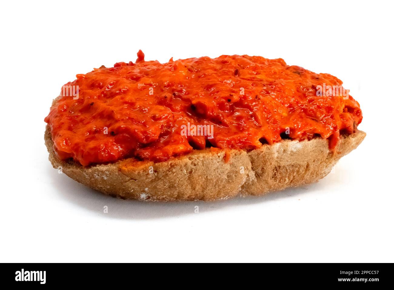 Ajvar roasted red peppers spread on bread isolated on white background ...