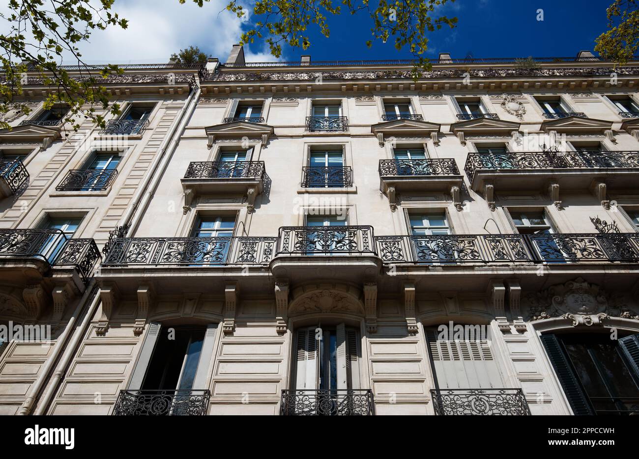 The facade of traditional French house with typical balconies and ...