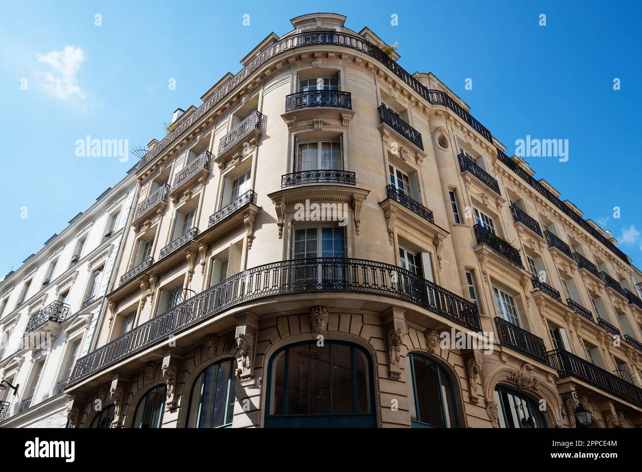 The facade of traditional French house with typical balconies and ...