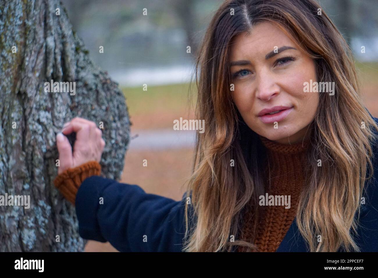 Female and young on tree trunk hi-res stock photography and images - Alamy