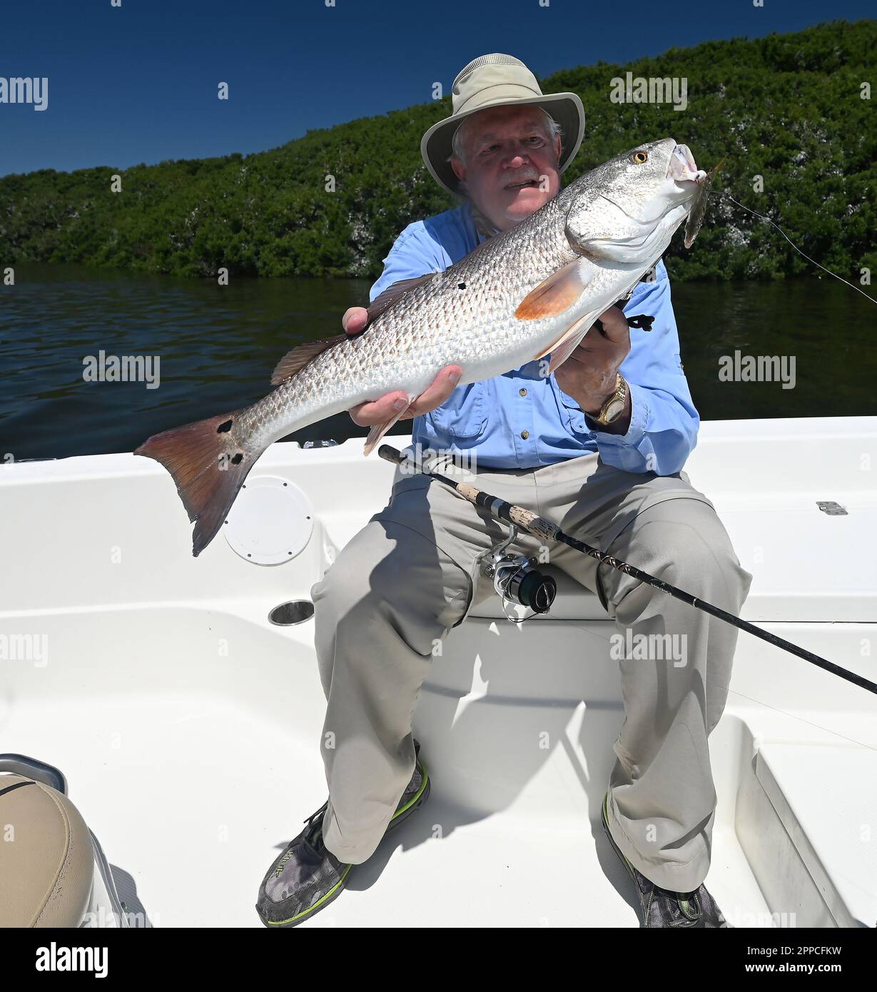An angler admires a nice catch from the flats and islands off Crystal ...