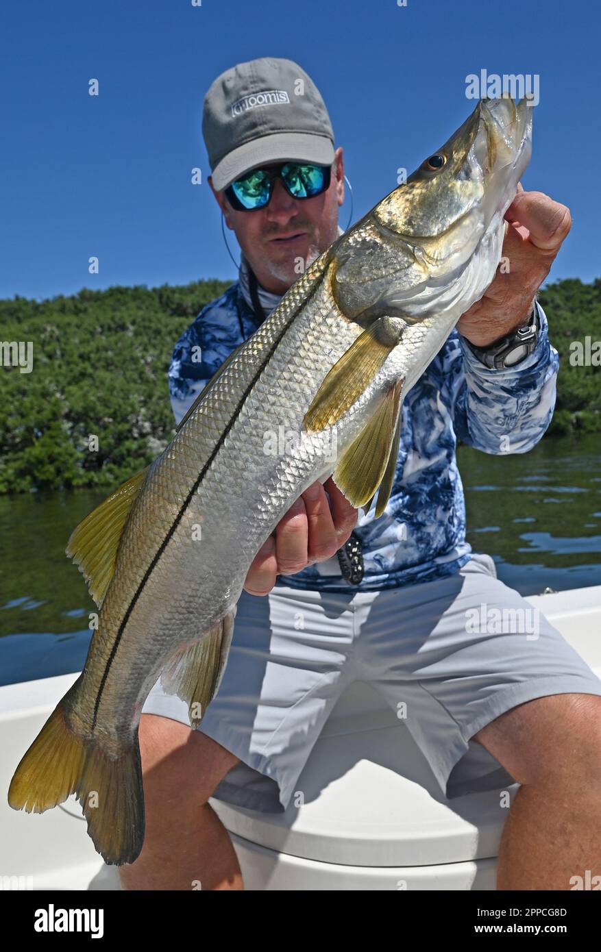 An angler admires a nice catch from the flats and islands off Crystal ...