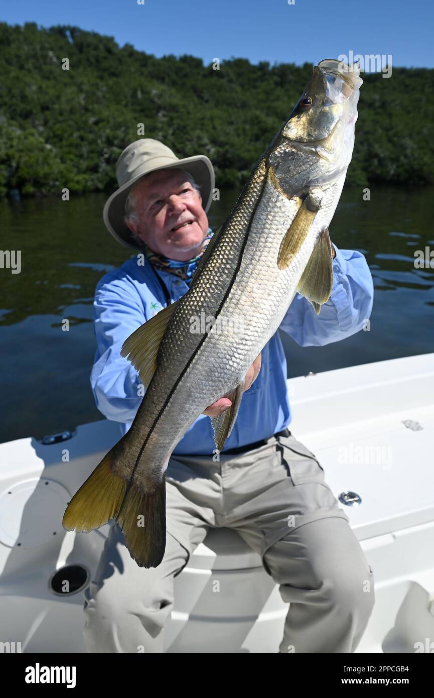 An angler admires a nice catch from the flats and islands off Crystal ...